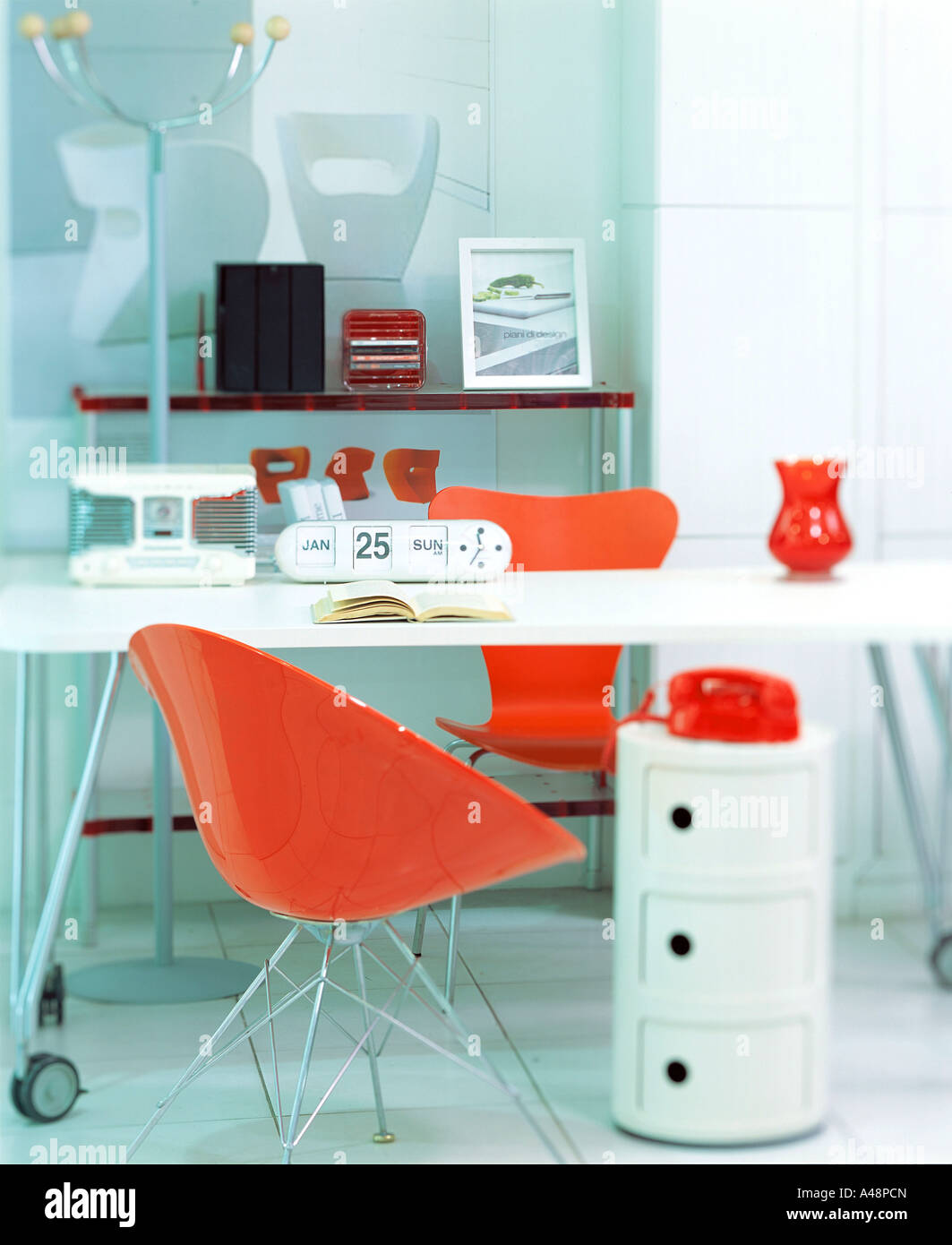 Two plastic chairs near a desk Stock Photo - Alamy