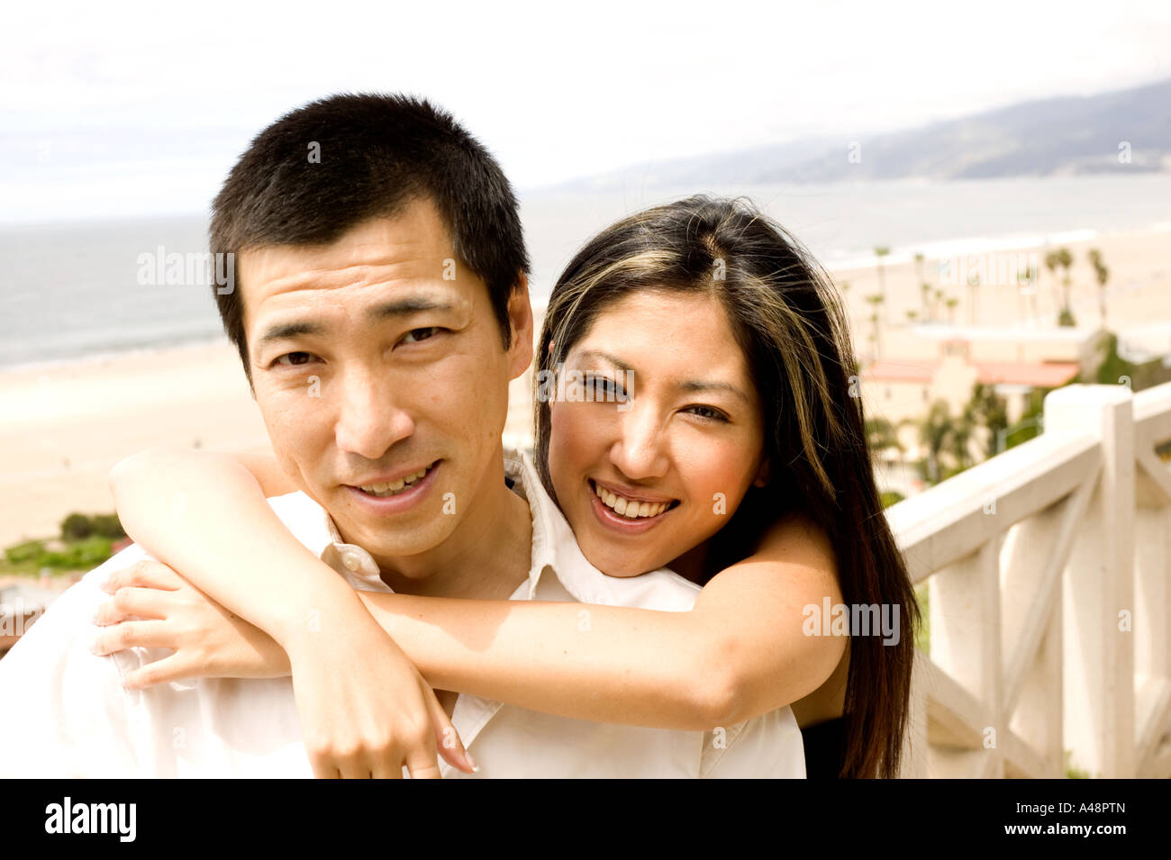 Woman embracing boyfriend, portrait Stock Photo - Alamy