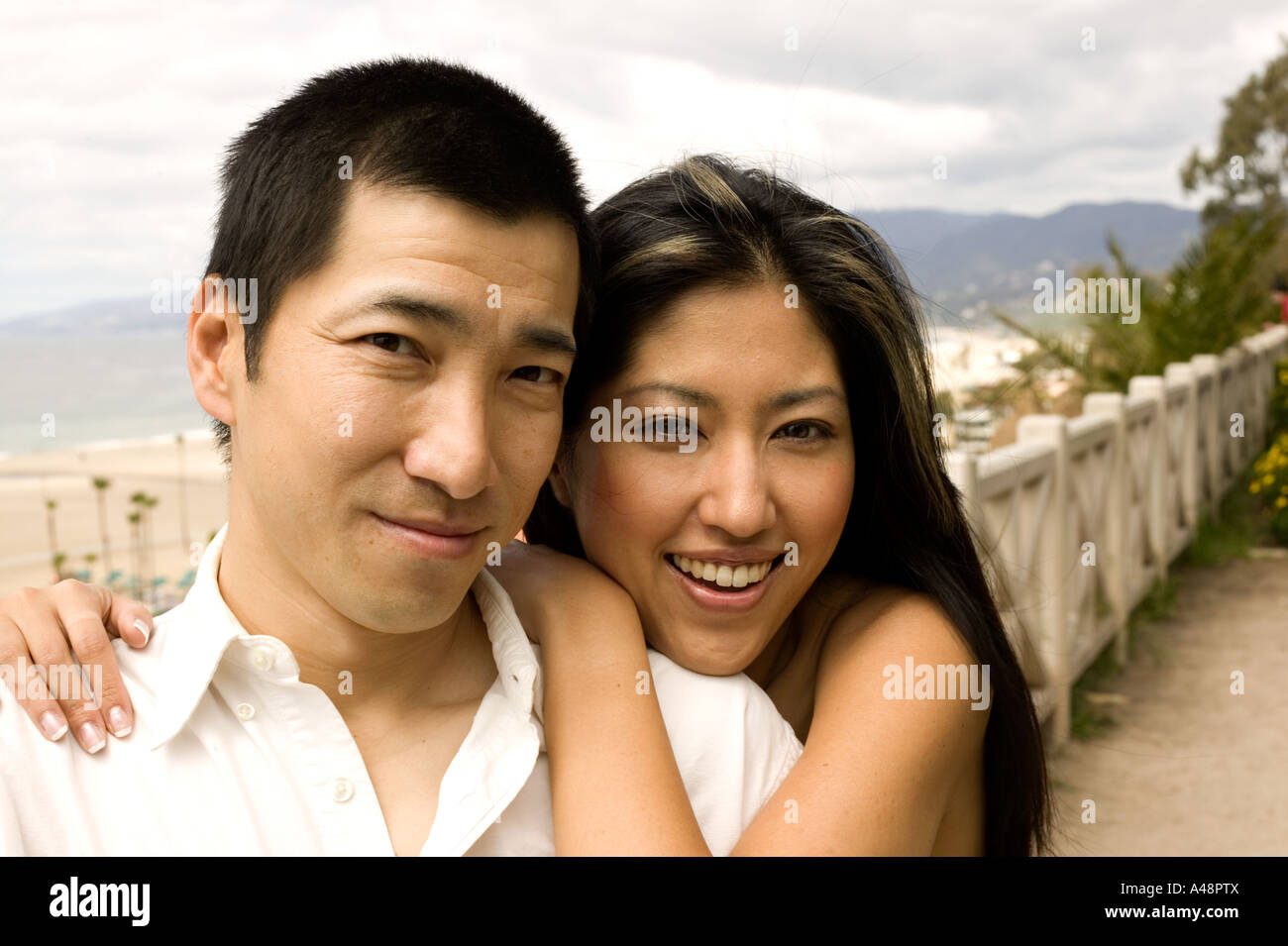 Woman embracing boyfriend, portrait Stock Photo - Alamy