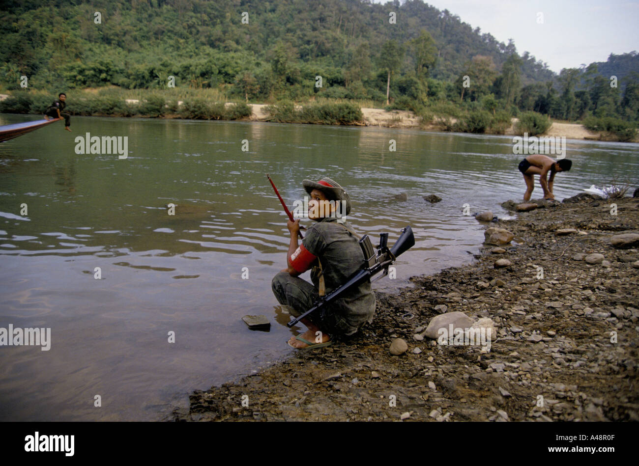 karen soldiers guarding a supply boat on river moei. manerplaw burma ...