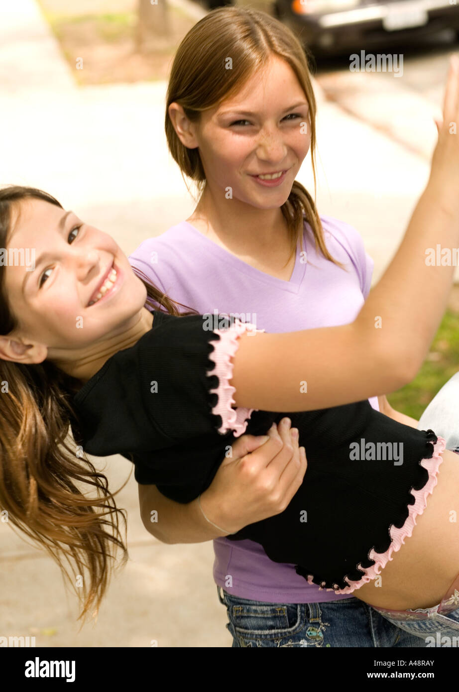 Girl carrying sister, smiling, portrait Stock Photo - Alamy Girl carrying sister, smiling, portrait Stock Photo - Alamy