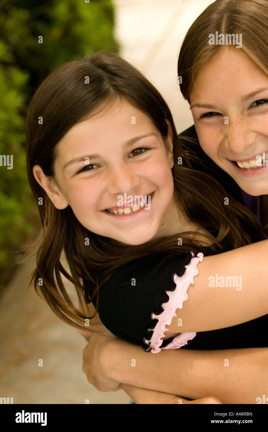 Girl embracing sister, smiling, portrait Stock Photo - Alamy