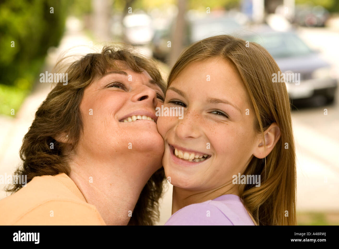 Daughter embracing mother, smiling, portrait Stock Photo - Alamy