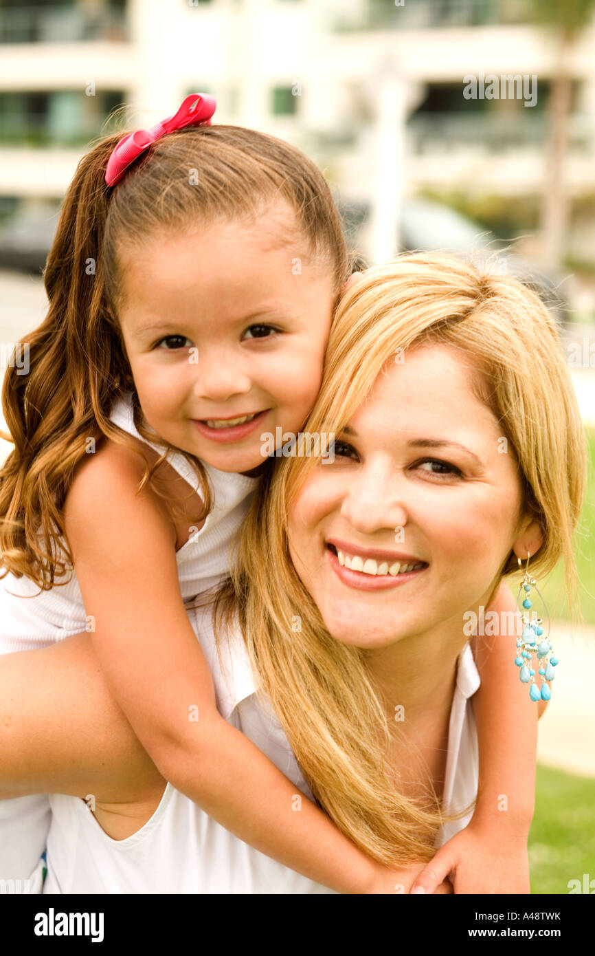 Happy parents piggybacking kids hi-res stock photography and images - Alamy