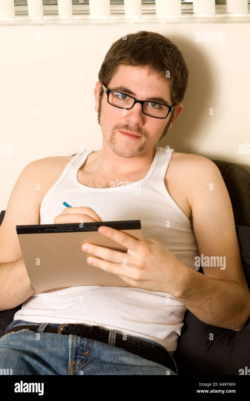Young man holding notepad, portrait Stock Photo - Alamy