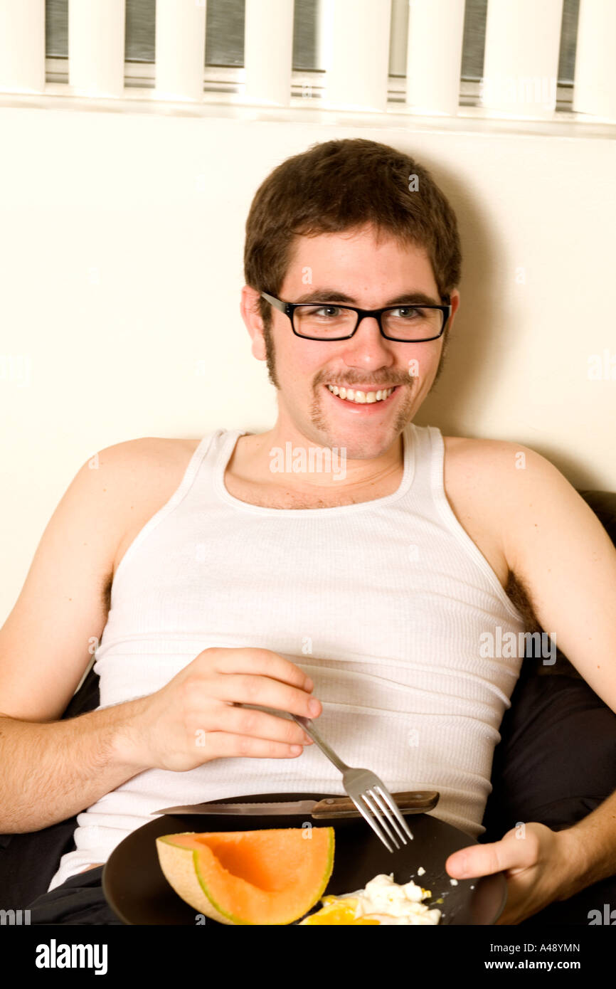 Young man holding plate Stock Photo - Alamy