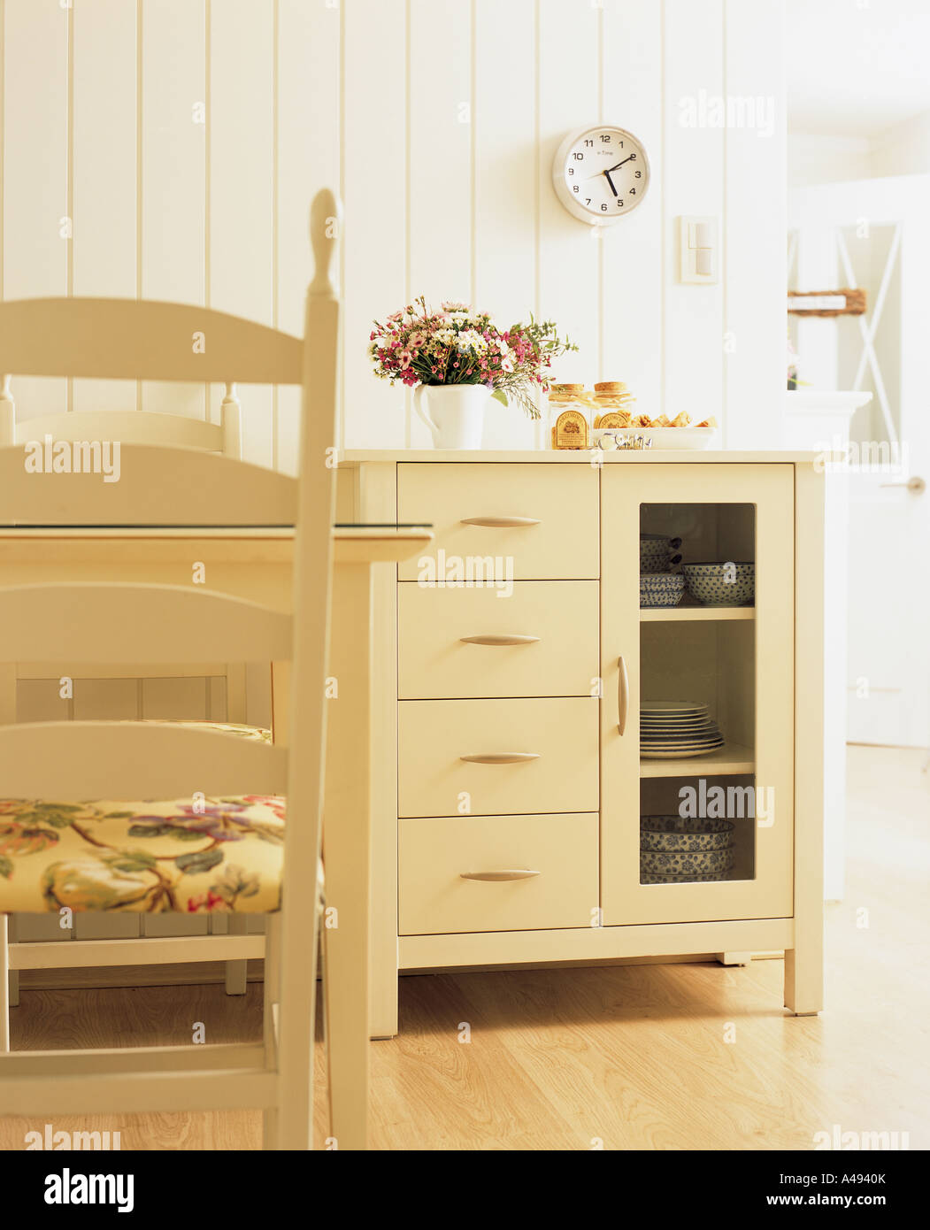 Cabinet and a chair in the living room Stock Photo - Alamy