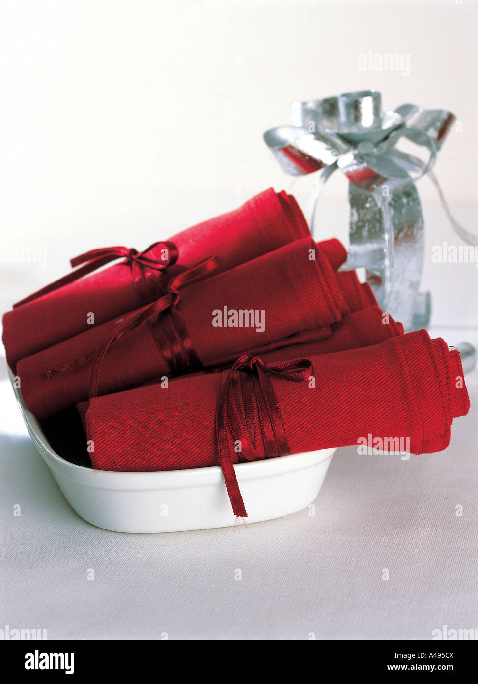 Close-up of rolled up red napkins in a bowl Stock Photo - Alamy