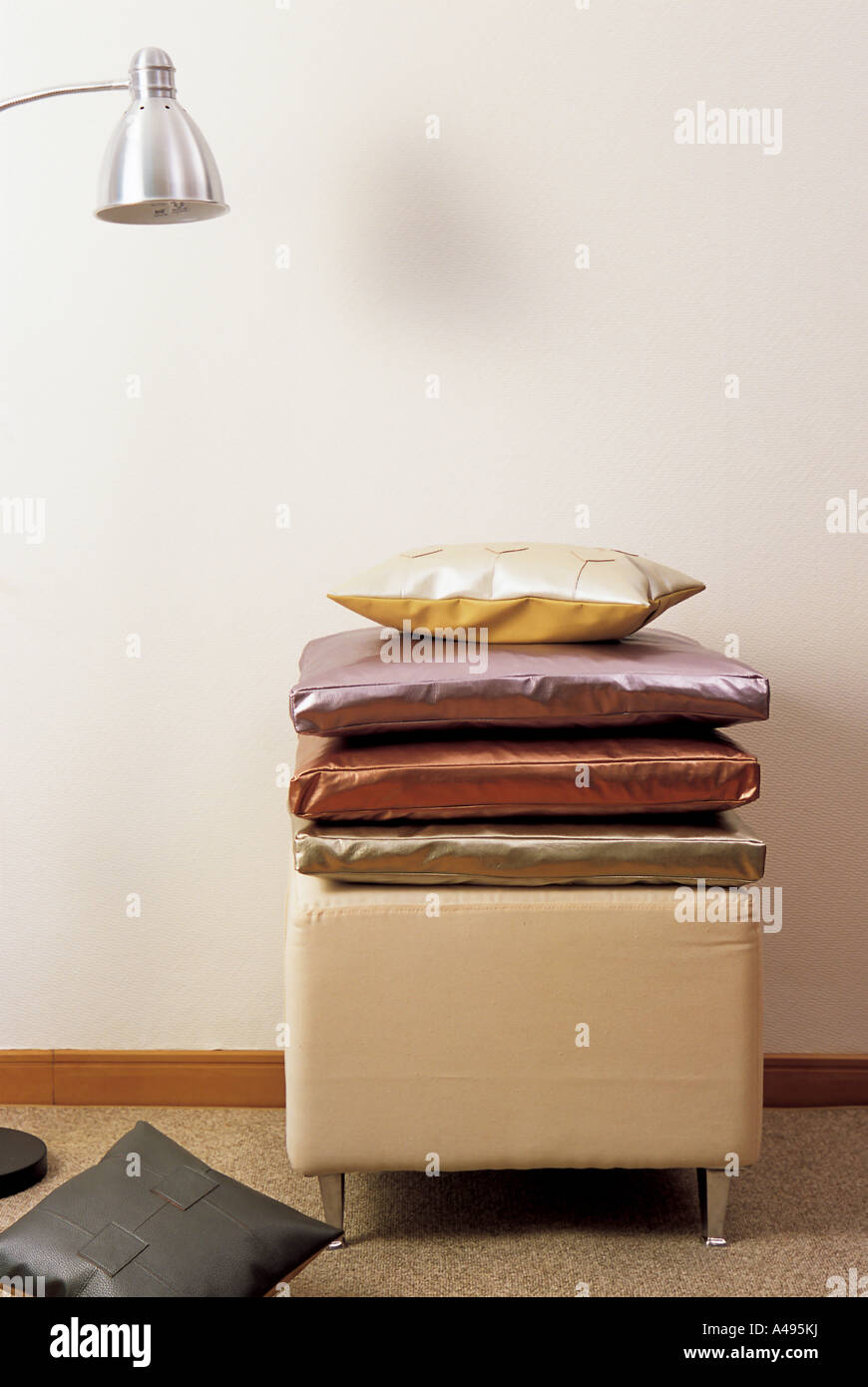 Stack of cushions on a stool Stock Photo - Alamy