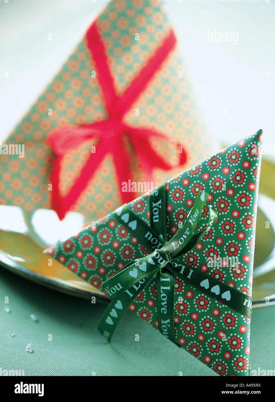 Close-up of triangular shaped gifts tied with ribbons Stock Photo - Alamy