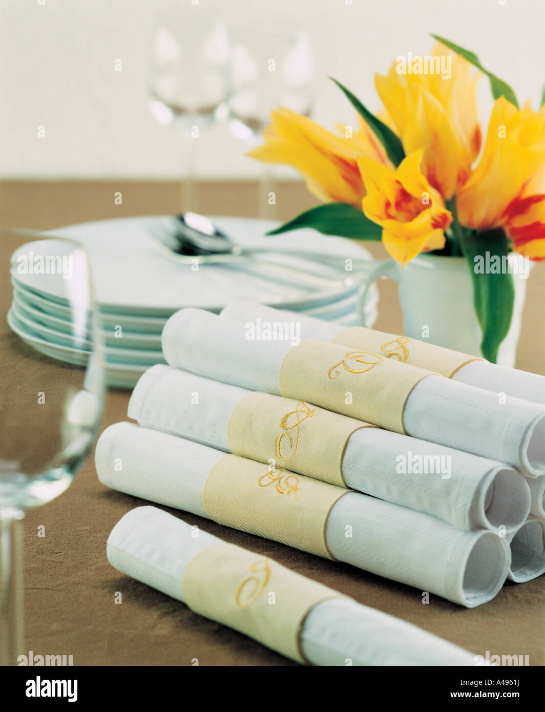 Close-up of rolled up napkins on the dining table Stock Photo - Alamy