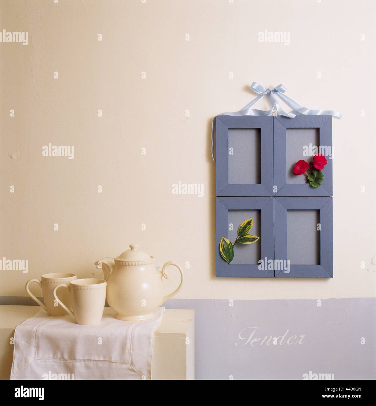 Kettle and two mugs on the table with a window frame on the wall Stock ...