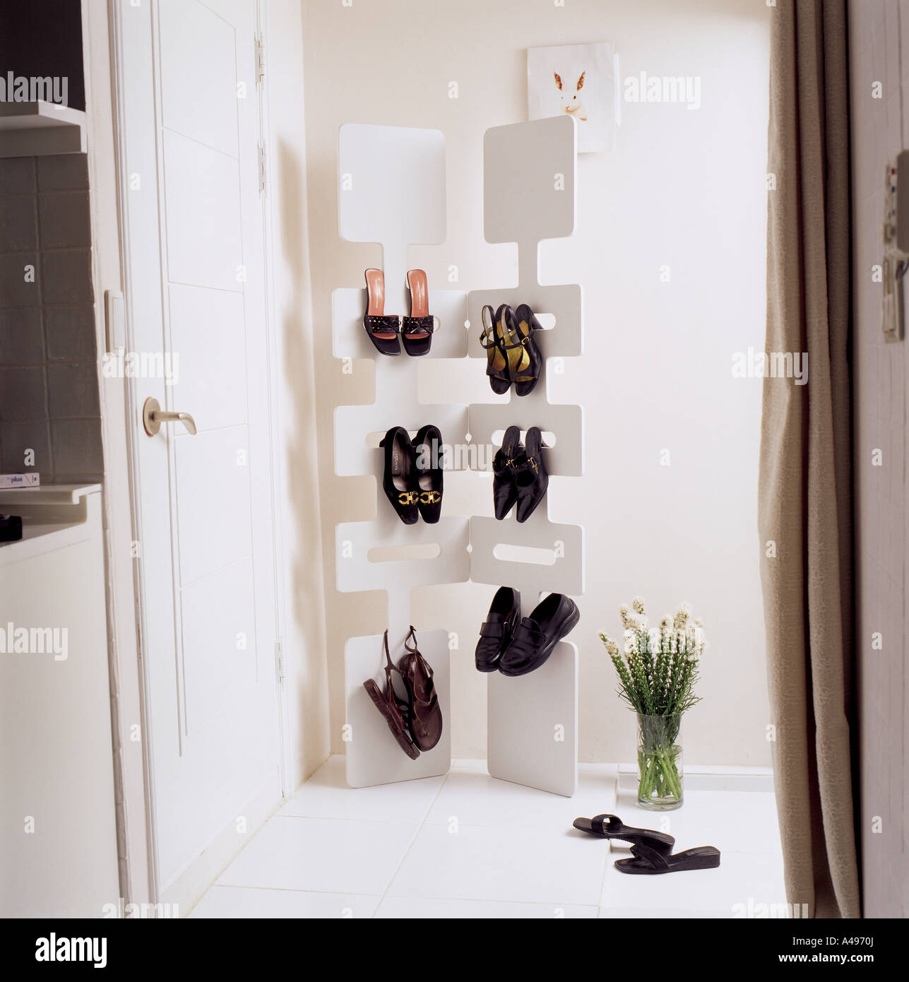 Pair of shoes and sandals hanging on a rack Stock Photo - Alamy