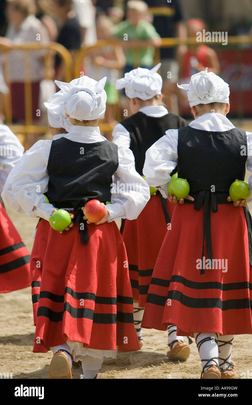 Basque girls performing Basque folk dance holding apples in hands ...