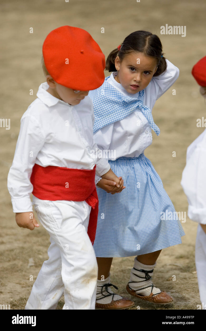 Very young Basque boy and girl holding hands wearing traditional ...