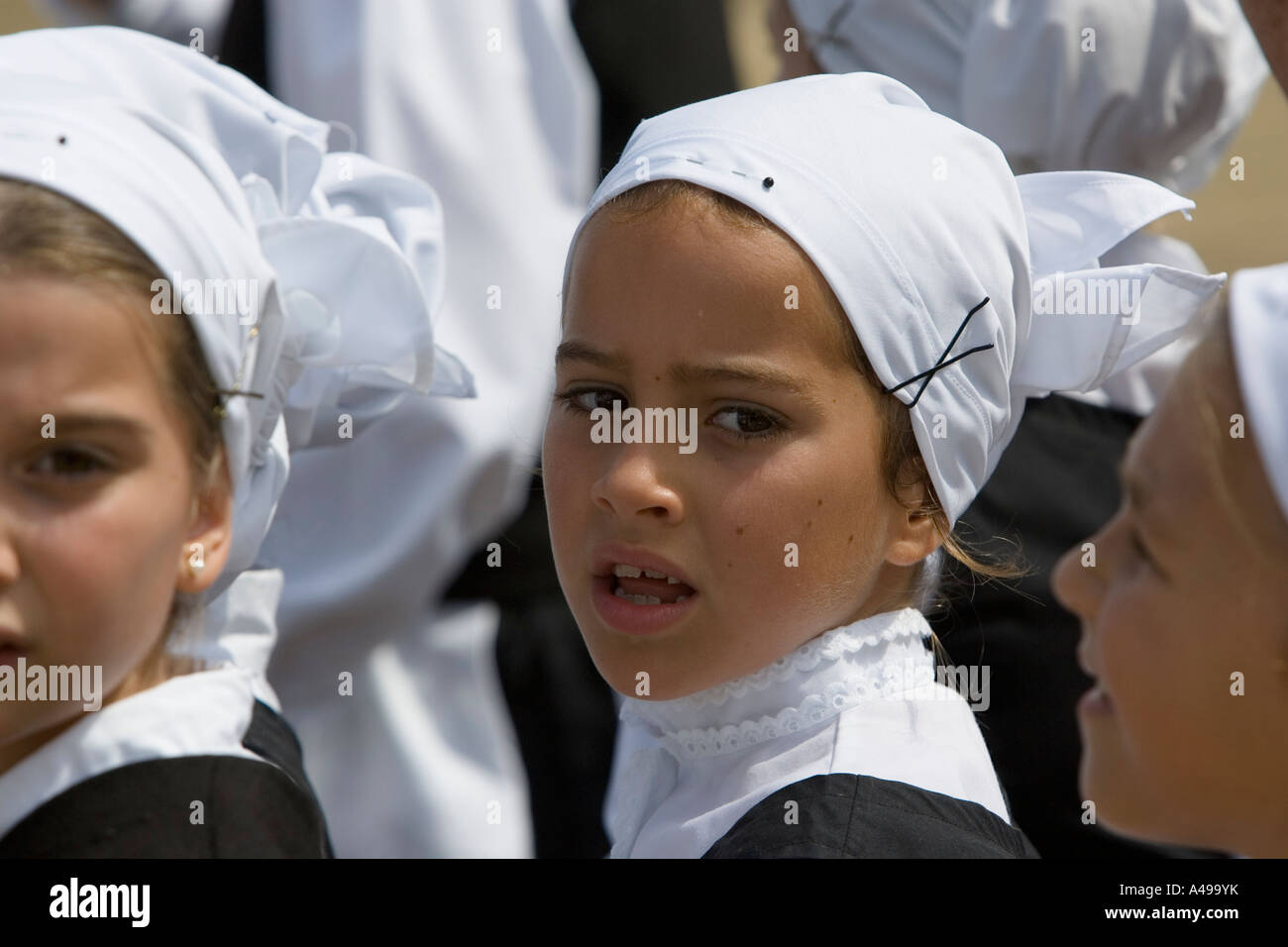 Face of young Basque girl wearing white headscarf during fiesta Andra ...
