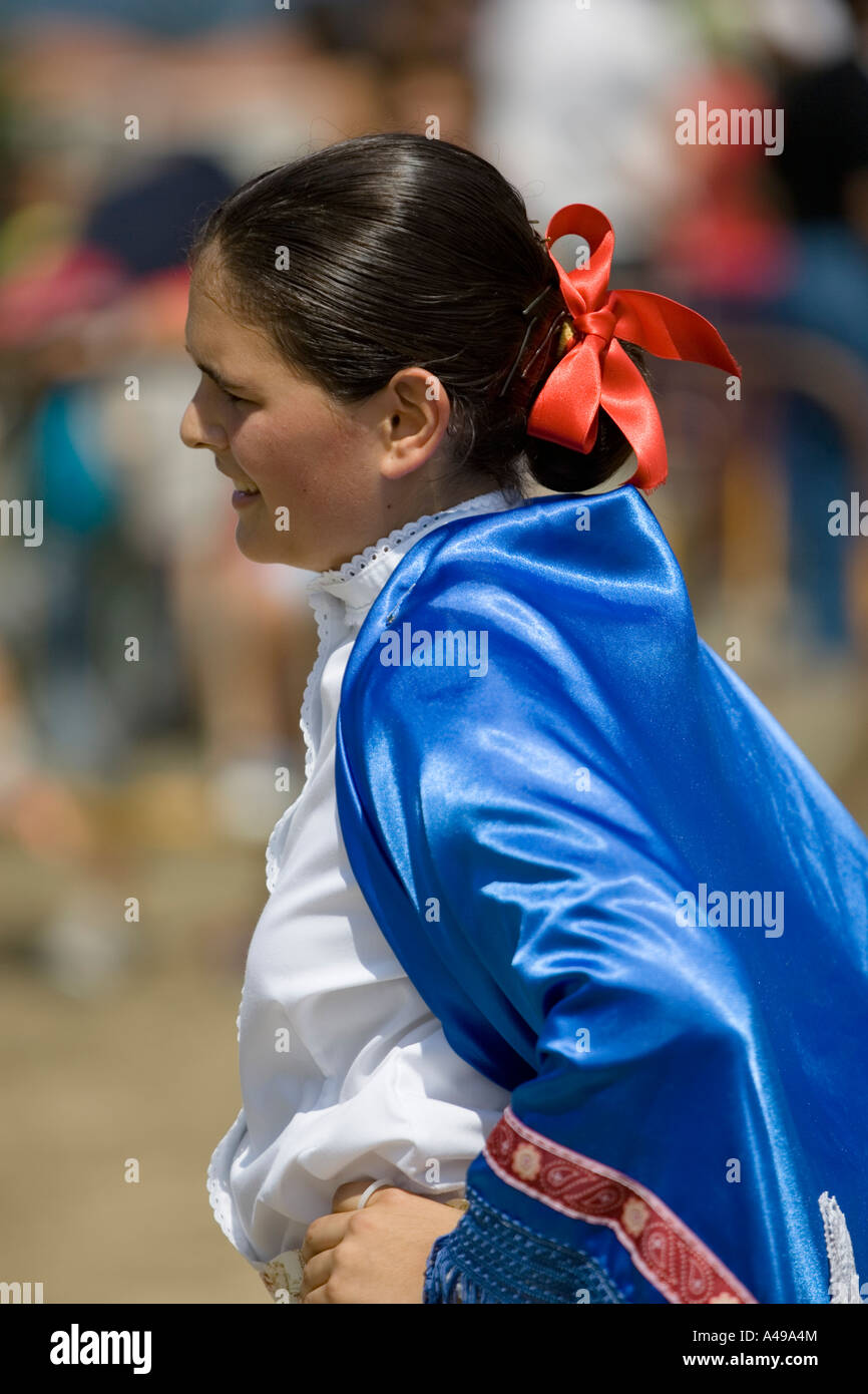Female Basque folk dancer wearing blue shawl and red hair ribbon fiesta ...