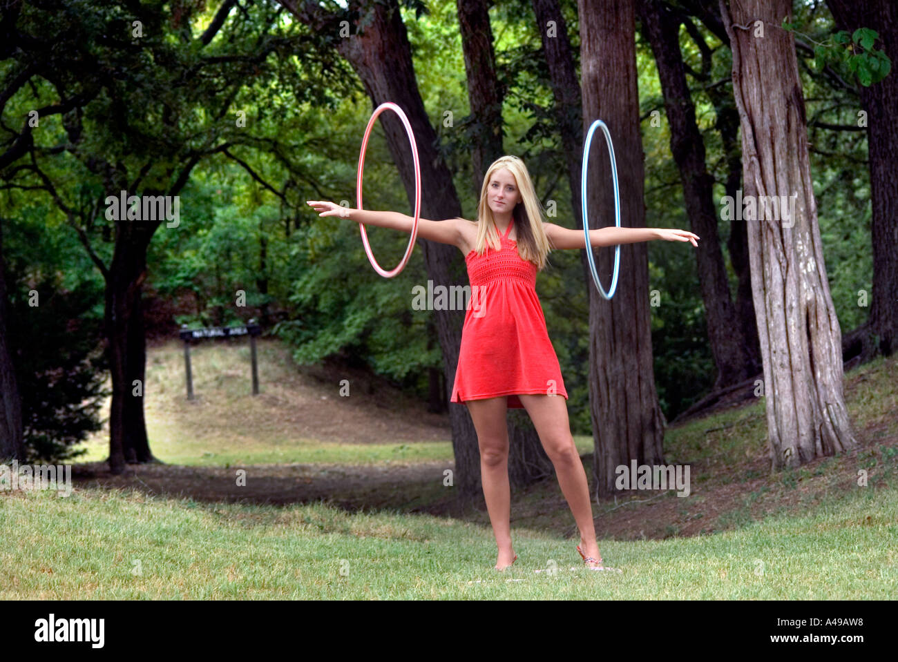 Girl twirling hoola hoops on arms Stock Photo - Alamy