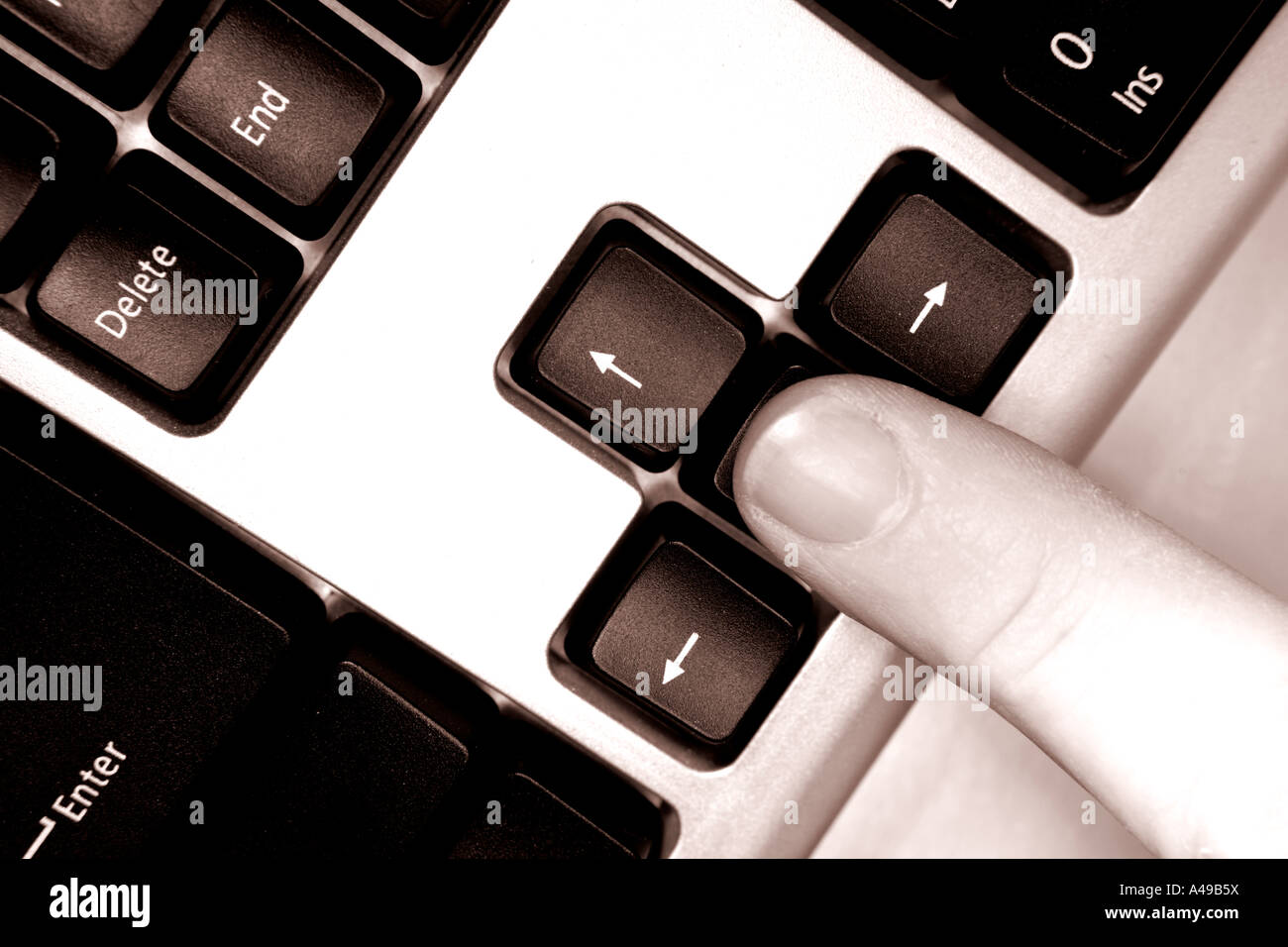 Finger on arrow key of computer keyboard Stock Photo - Alamy