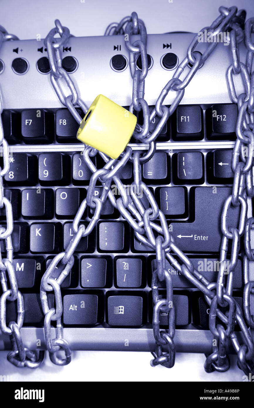 Padlock and chain around computer keyboard Stock Photo - Alamy