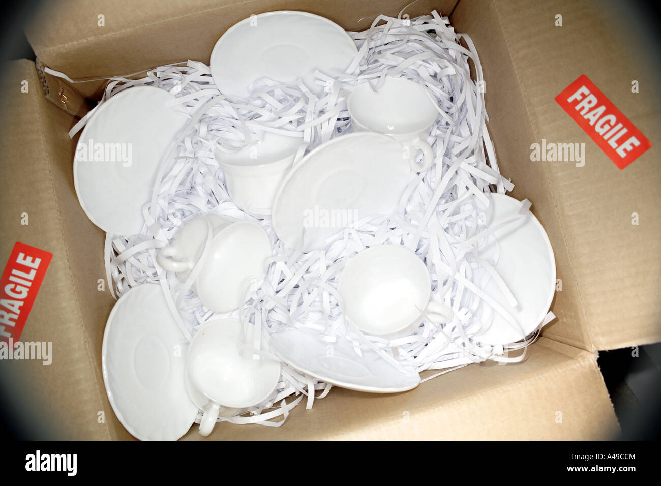 Cups and saucers in packing box Stock Photo - Alamy