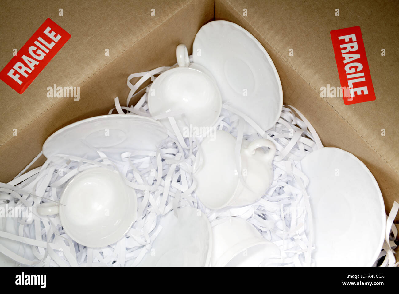 Cups and saucers in packing box Stock Photo - Alamy