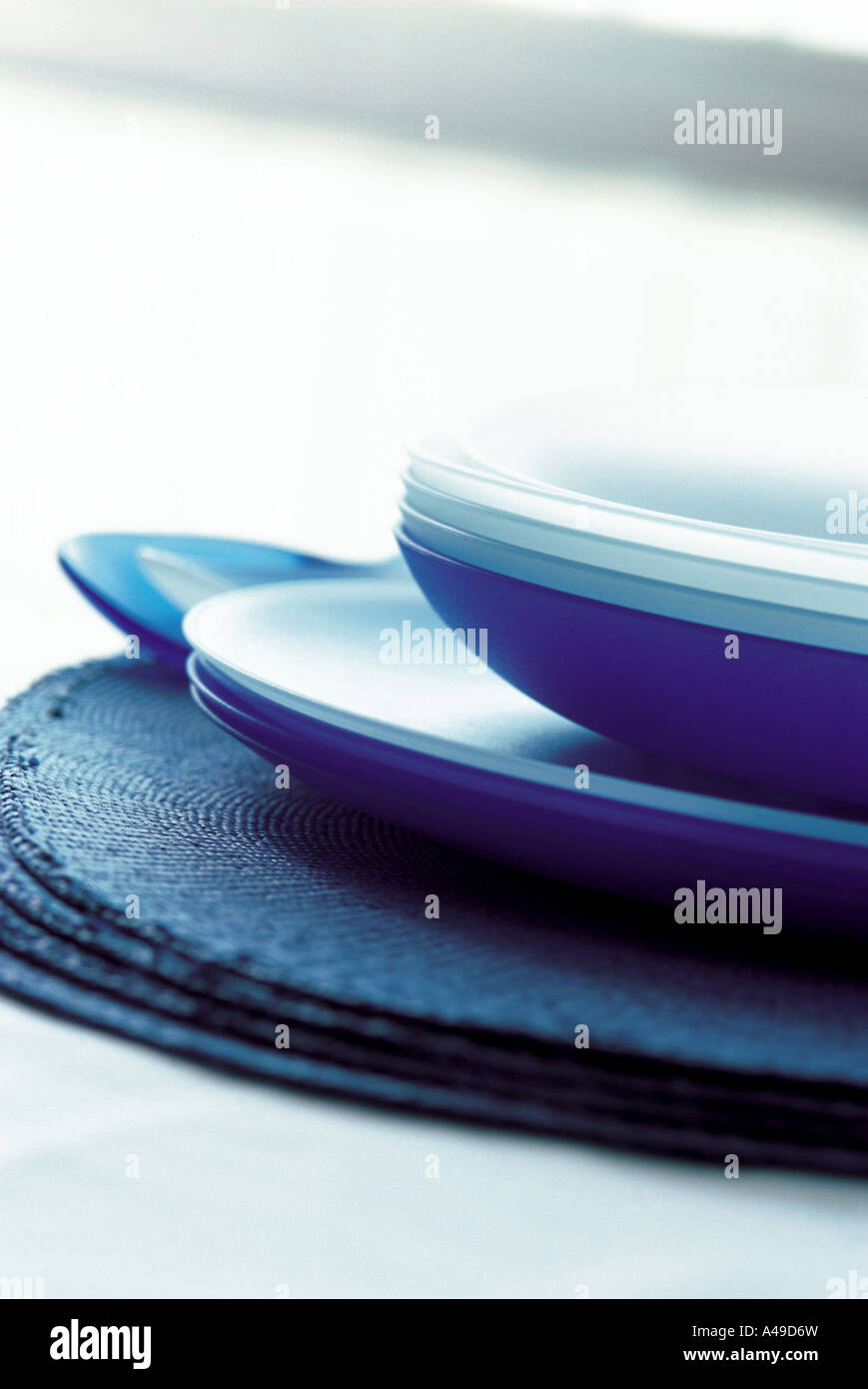 Stack of bowls and plates on place mats Stock Photo - Alamy