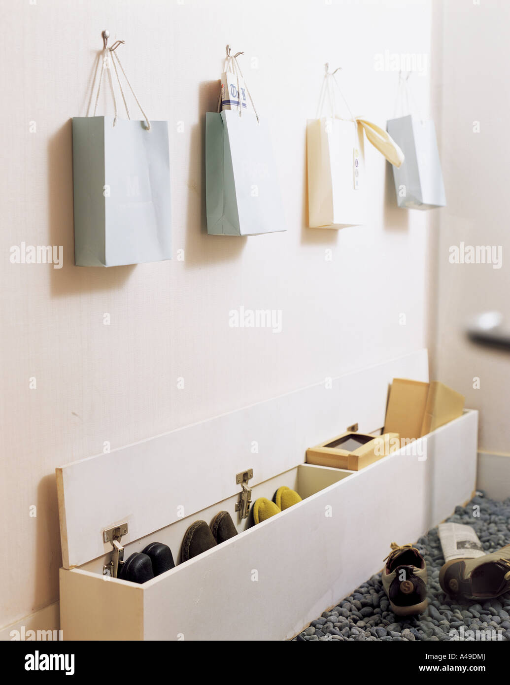 Paper bags hanging on hooks on the wall Stock Photo - Alamy