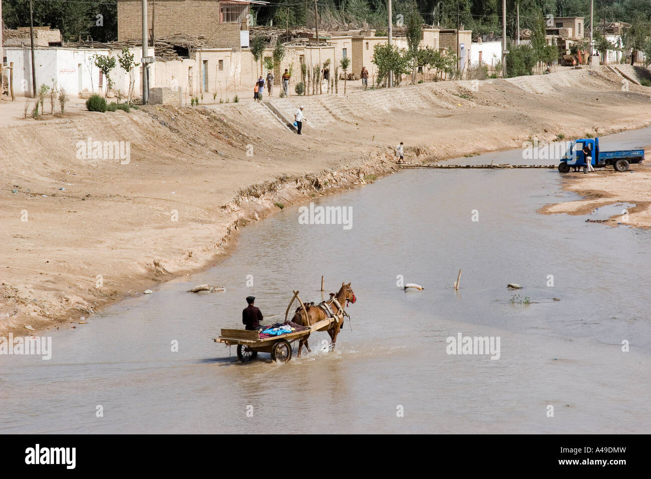 The river at Kuqu Xinjiang Province China is used as a thoroughfare for ...