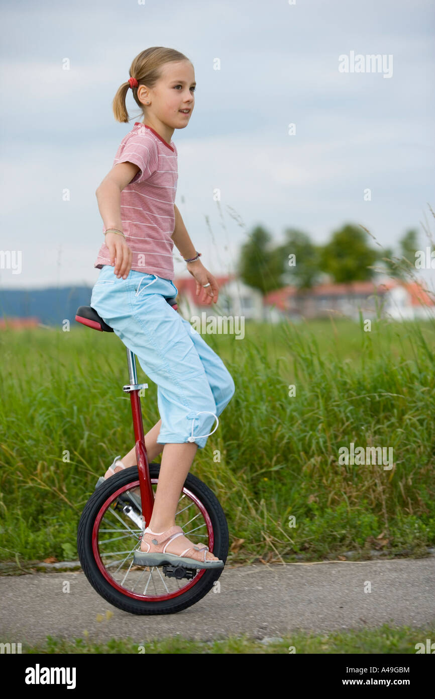 Girl riding a unicycle Stock Photo - Alamy