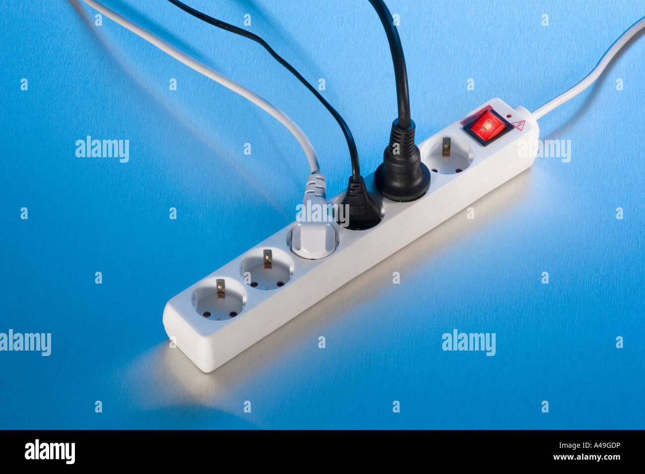 Multiple outlet strip on blue background Stock Photo - Alamy