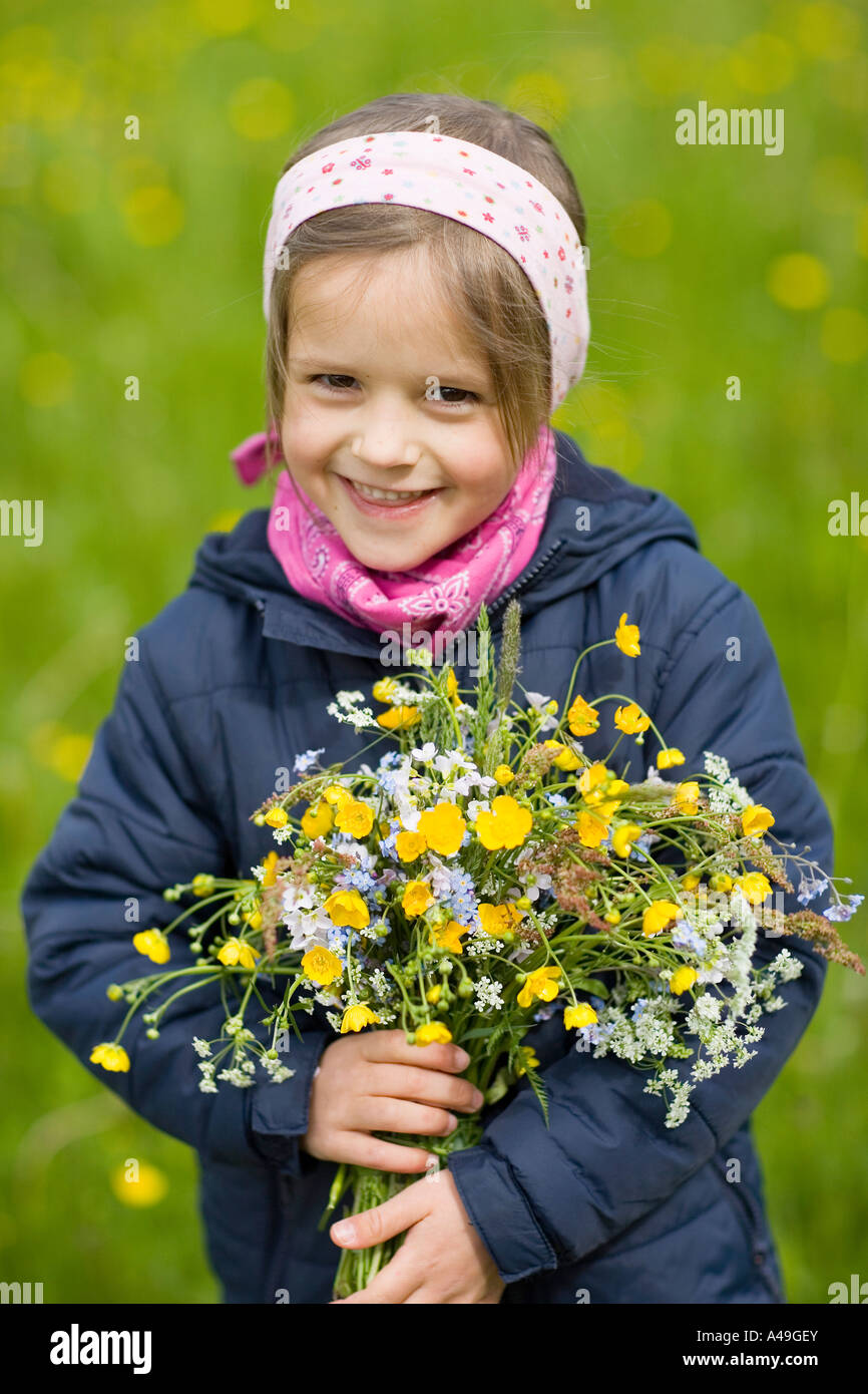 Smiling girl with flowers Stock Photo - Alamy