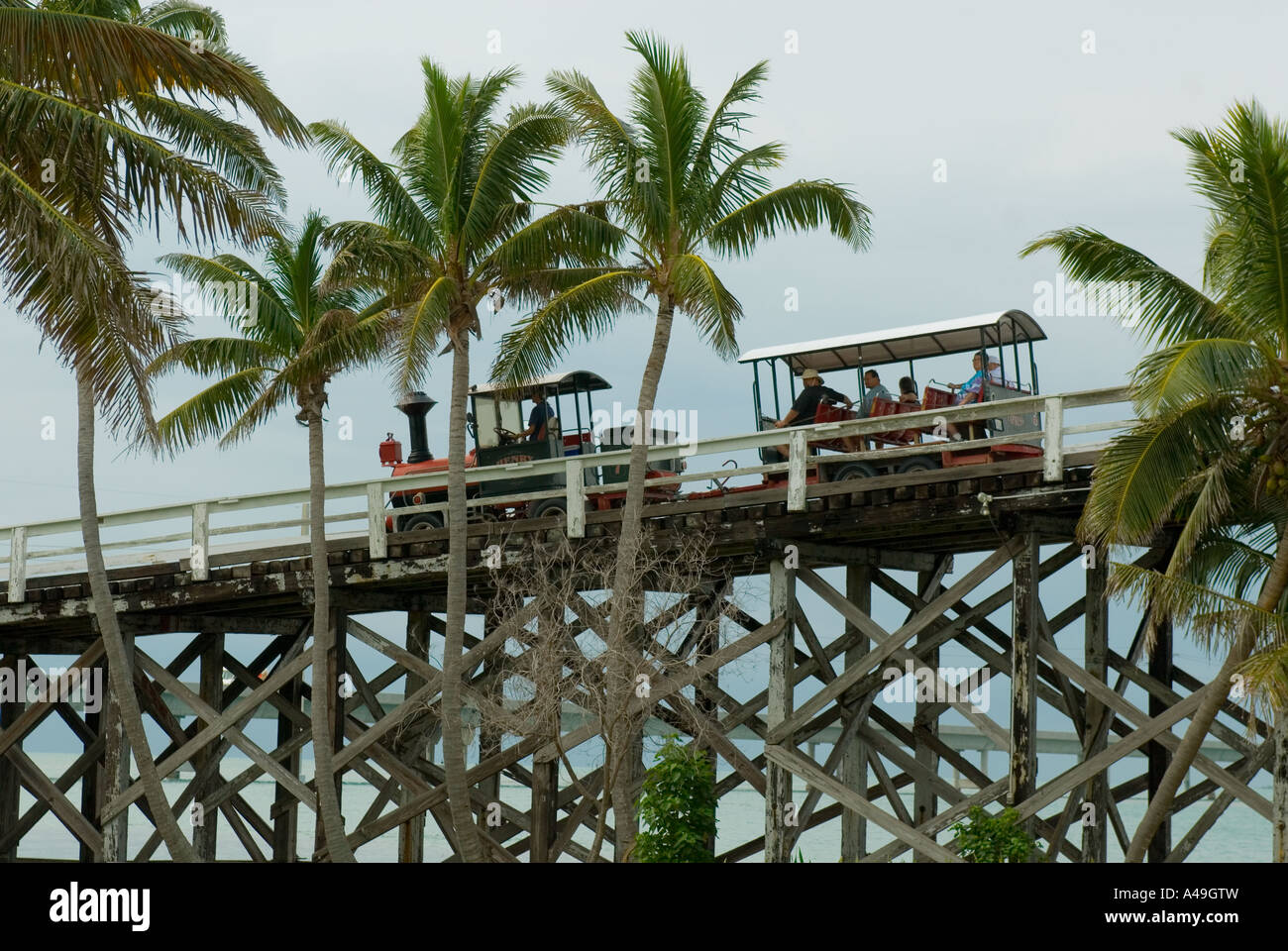 USA Florida Keys Pegion Key Tour Train driving tourists down old wooden ...