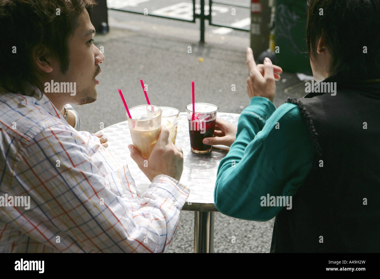 Two people sitting together and holding glasses in a restaurant Stock ...