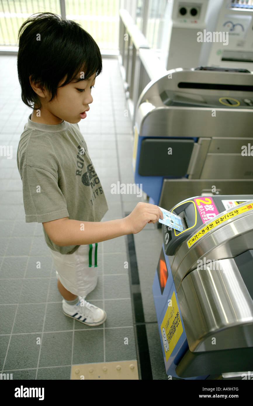Side profile of a boy using a machine at a subway station Stock Photo ...
