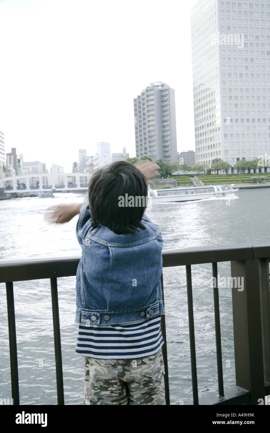 Rear view of a boy waving with hands Stock Photo - Alamy