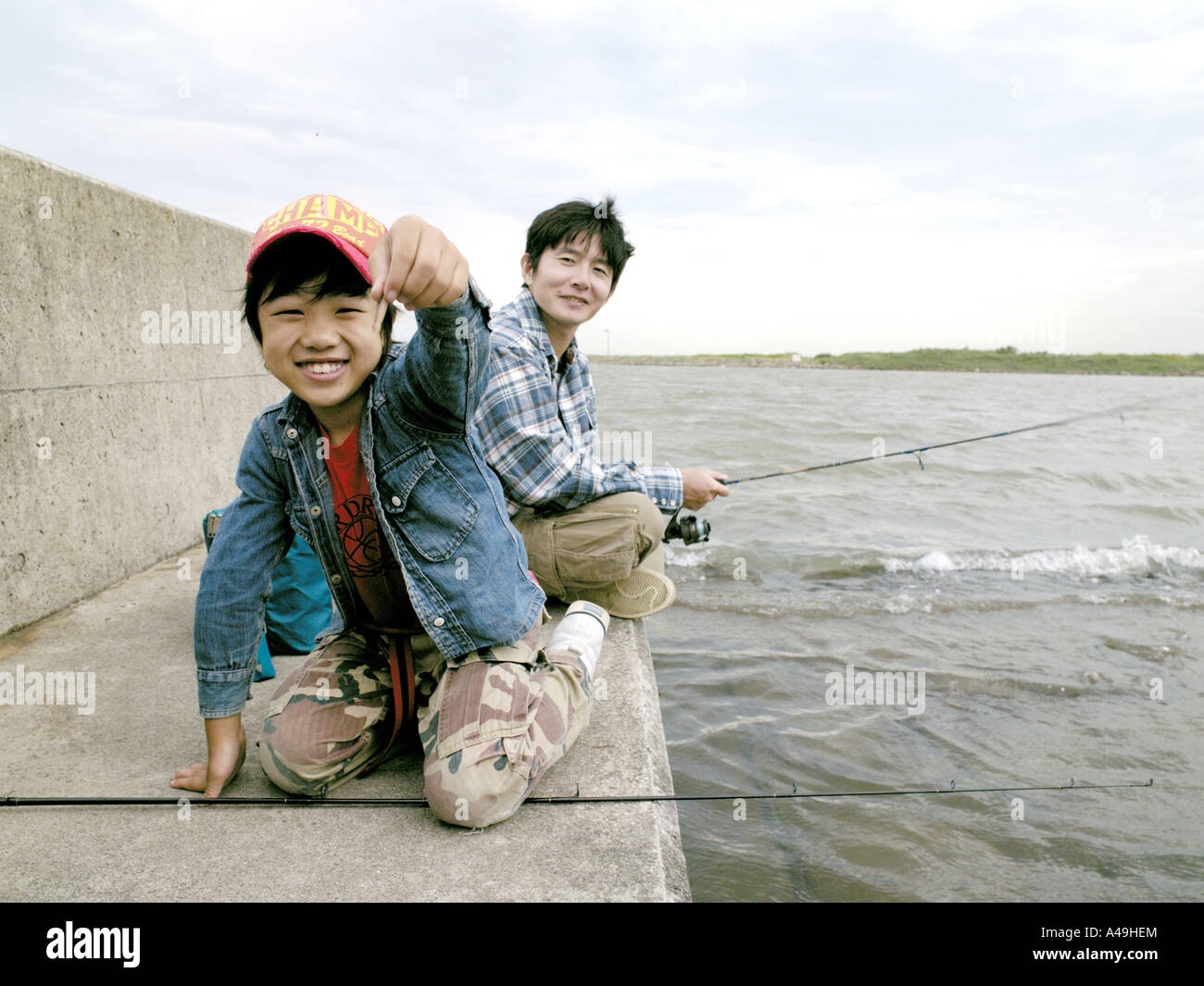 Close up of a child smiling and showing a fish Stock Photo - Alamy