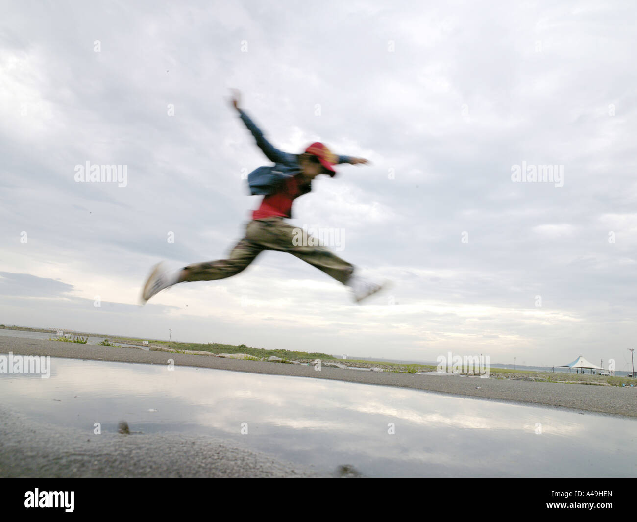 Side profile of a child jumping in air Stock Photo - Alamy