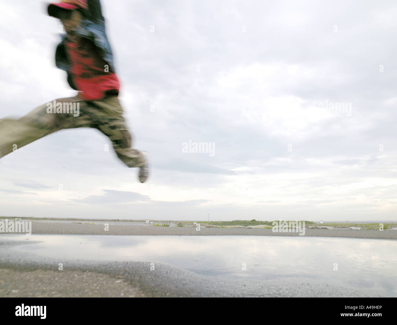Child jumping over water Stock Photo - Alamy