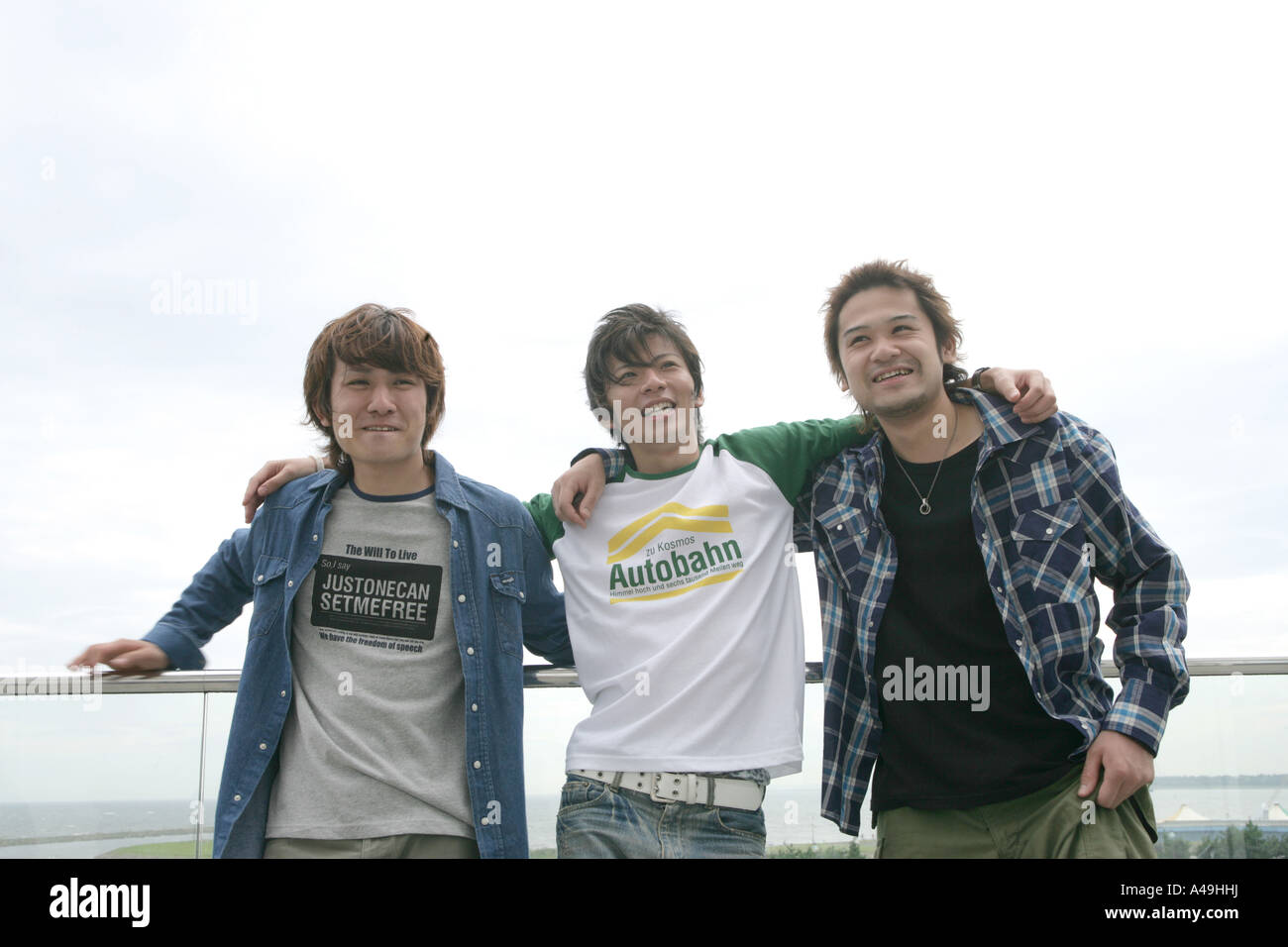 Portrait of three young men standing together Stock Photo - Alamy
