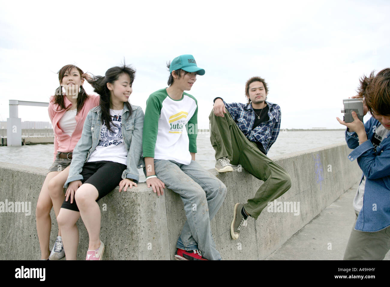 Young man taking a picture of four people Stock Photo - Alamy