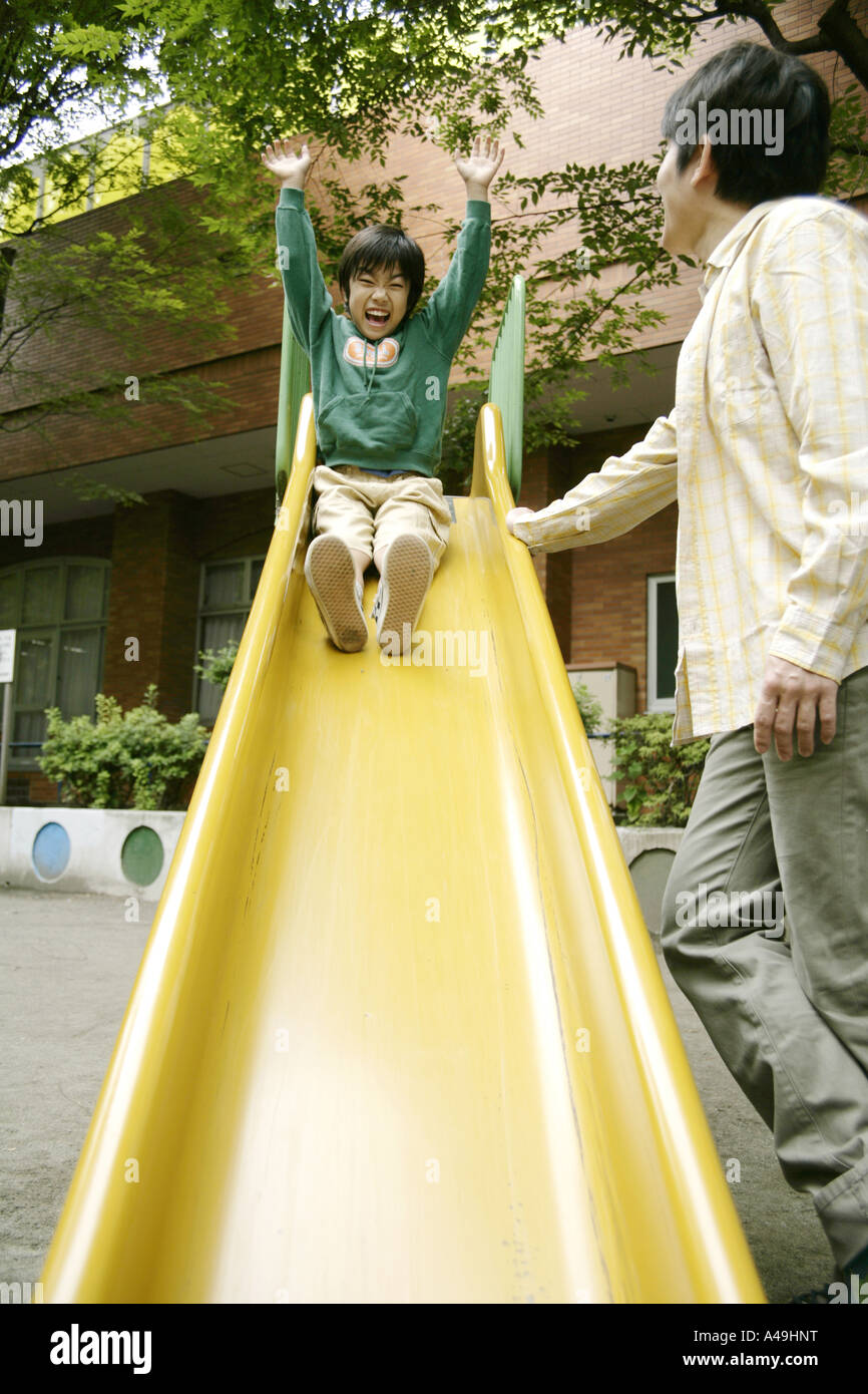 Asian boy sliding down slide hi-res stock photography and images - Alamy