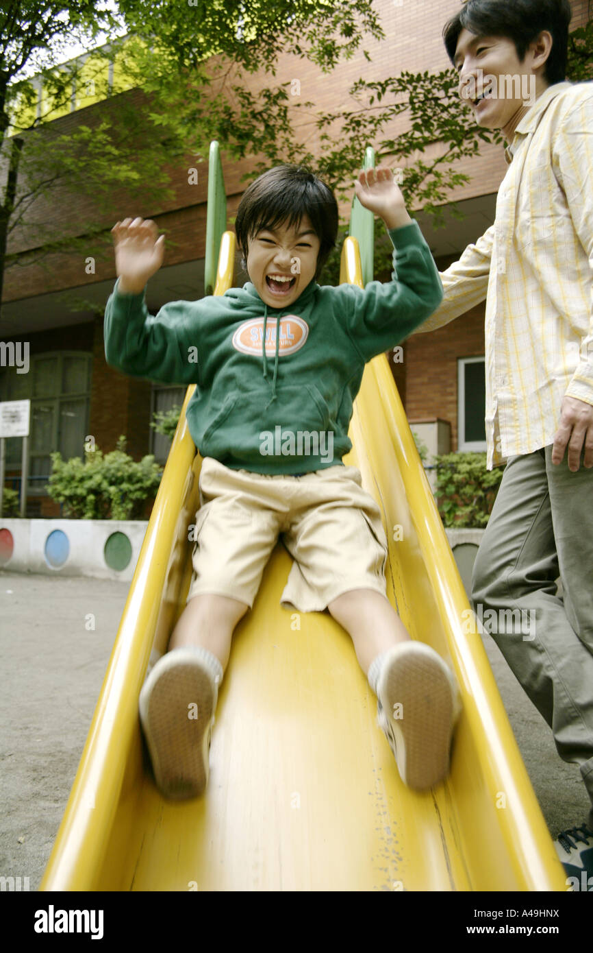 Asian boy sliding down slide hi-res stock photography and images - Alamy