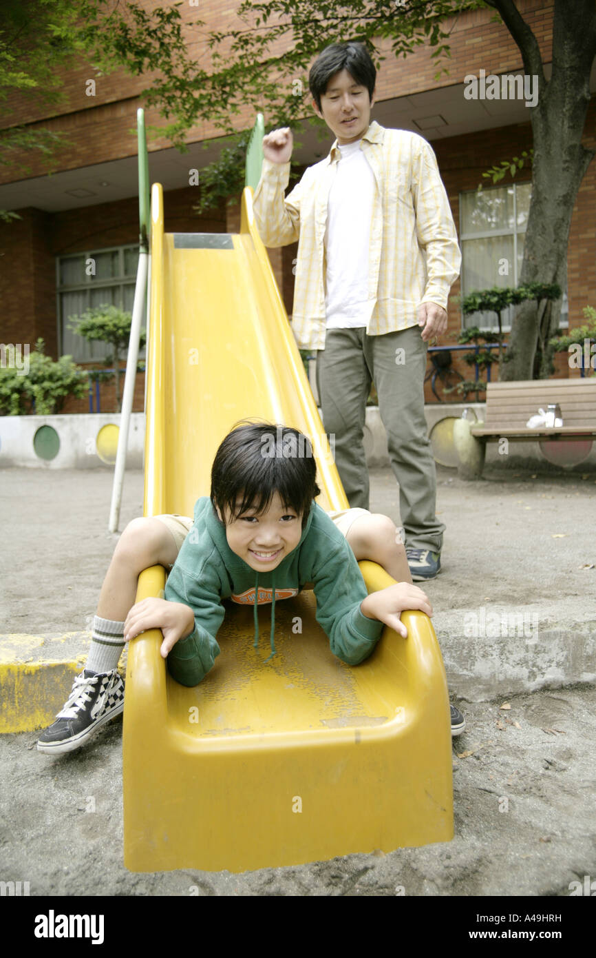 Asian boy sliding down slide hi-res stock photography and images - Alamy