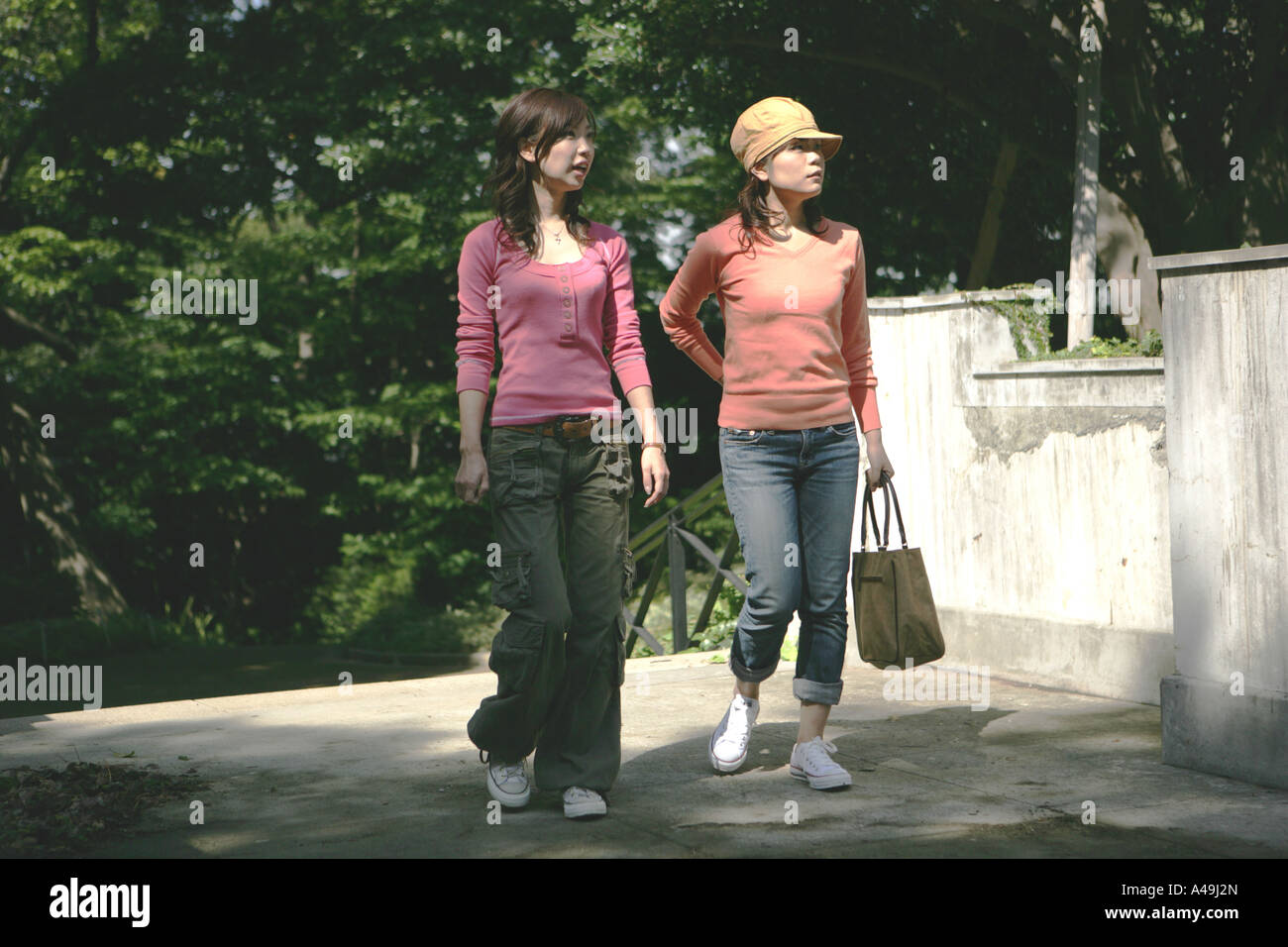 Two women walking on park hi-res stock photography and images - Alamy