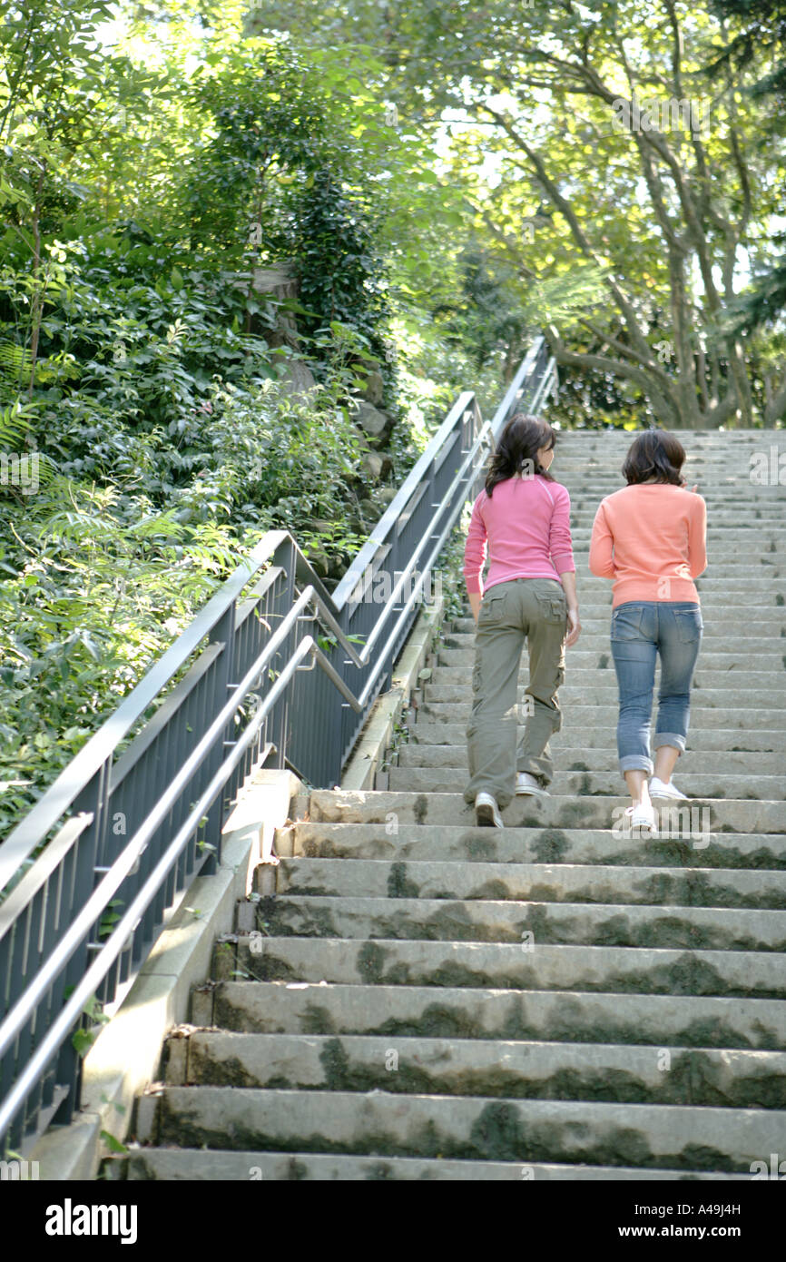 Two women walking up staircase hi-res stock photography and images - Alamy