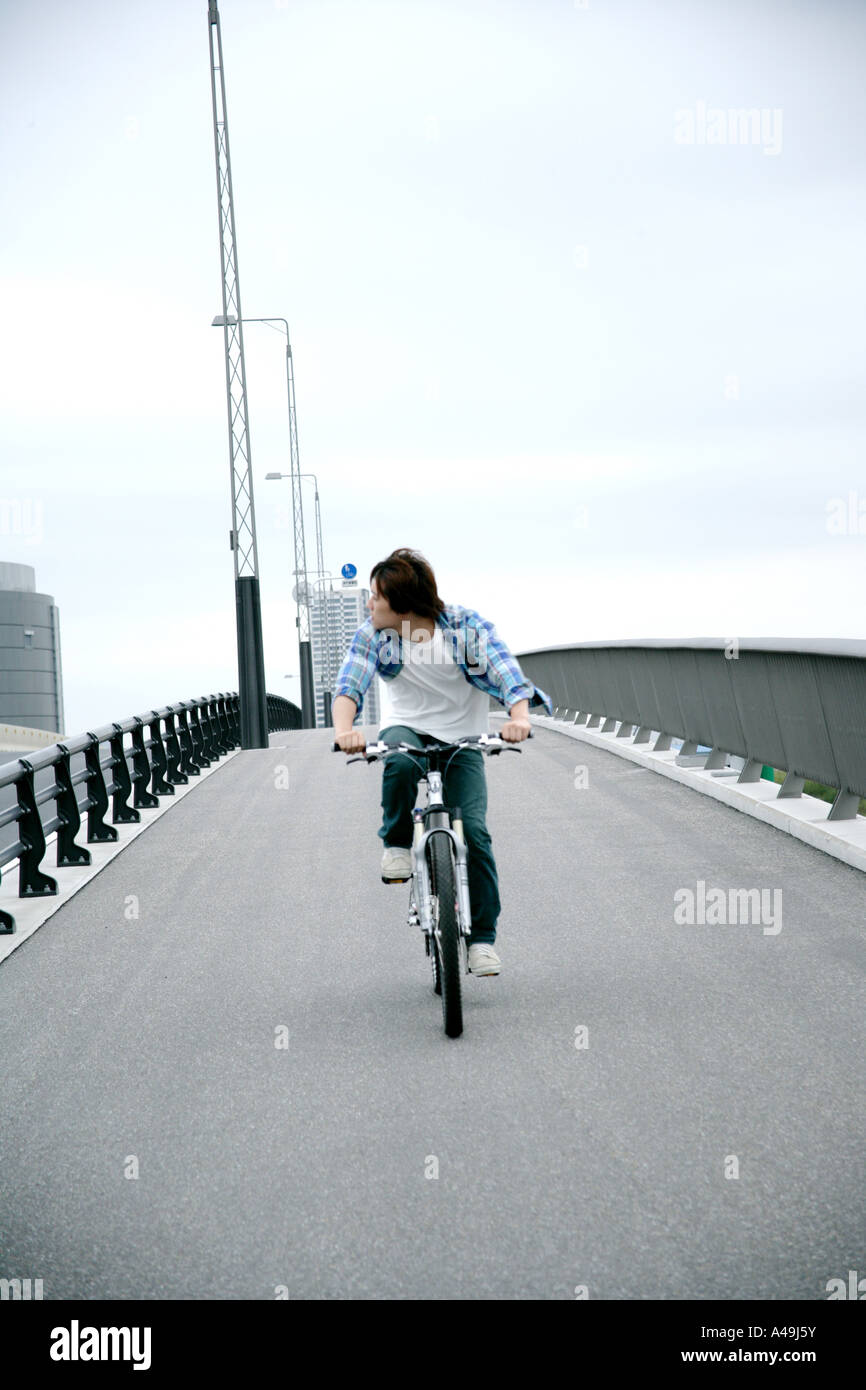 Young man riding a cycle Stock Photo - Alamy