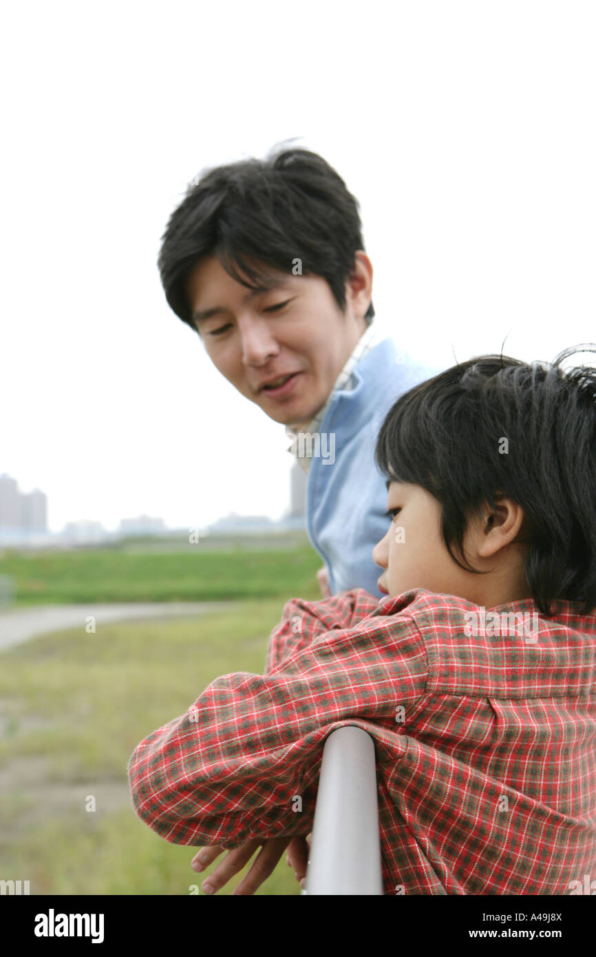 Side profile of a mid adult man talking to his son Stock Photo - Alamy