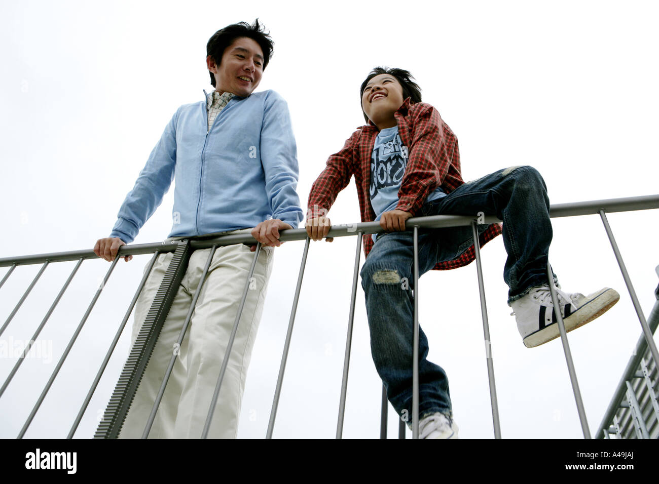Low angle view of a mid adult man and his son Stock Photo - Alamy