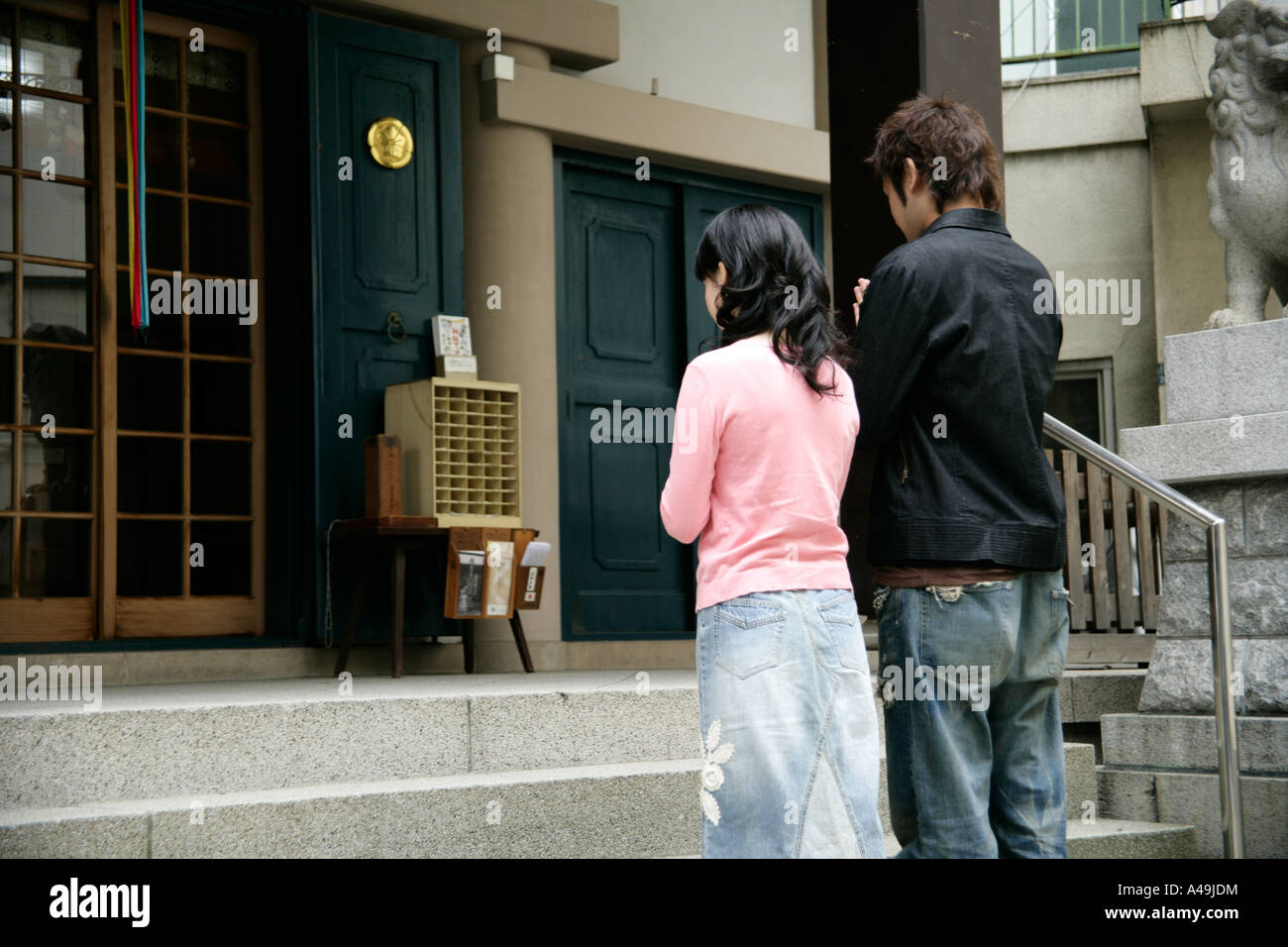 Rear view of a young couple praying Stock Photo - Alamy
